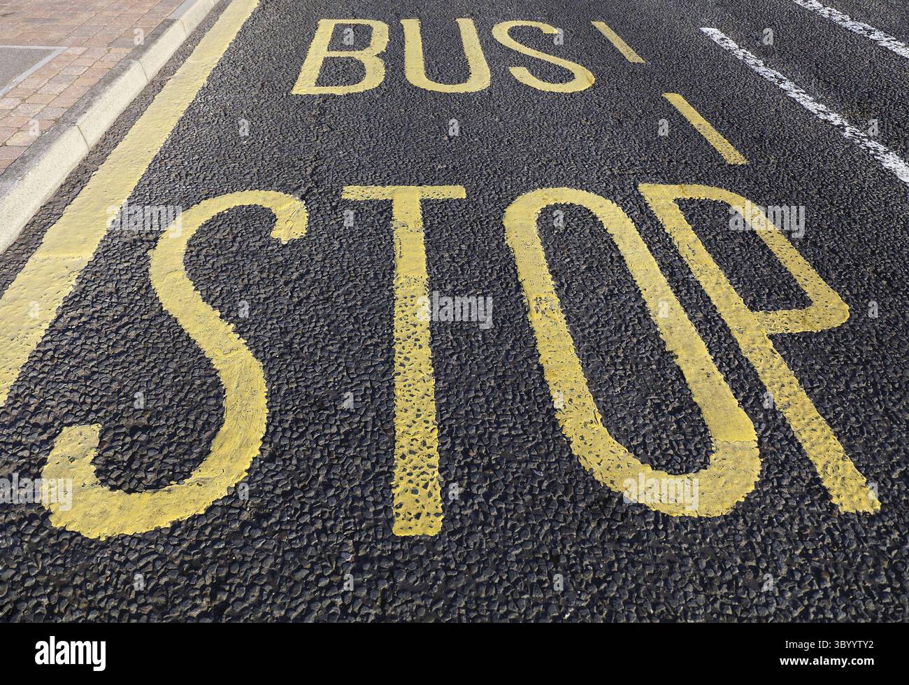 Bus stop sign painted on asphalt road Stock Photo - Alamy