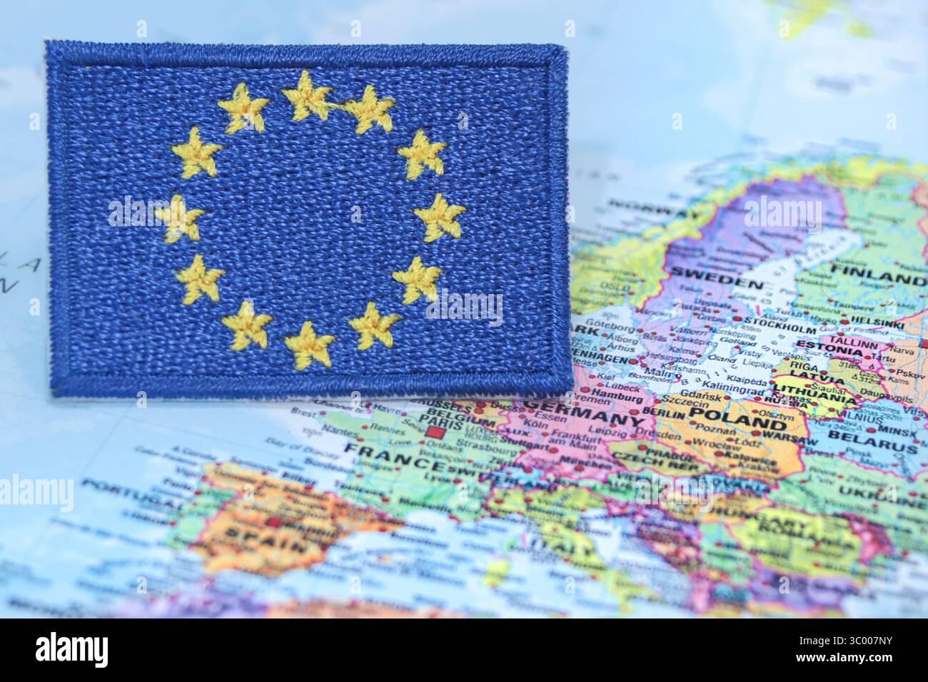 Textile EU flag stitched from thread and fabric, placed on a map over ...