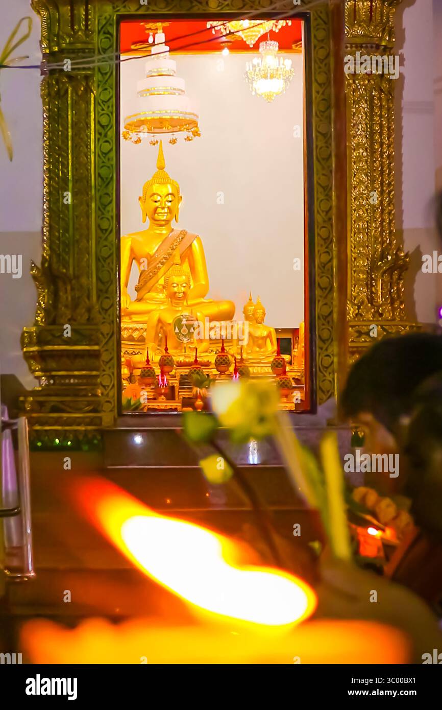 Thai Cultural Travel Candlelight walk at Thai temple. Foreground flame ...