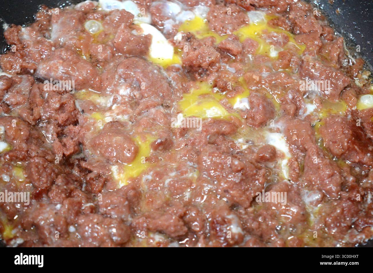 cooking eggs with corned salted beef, a variety of meat made from ...