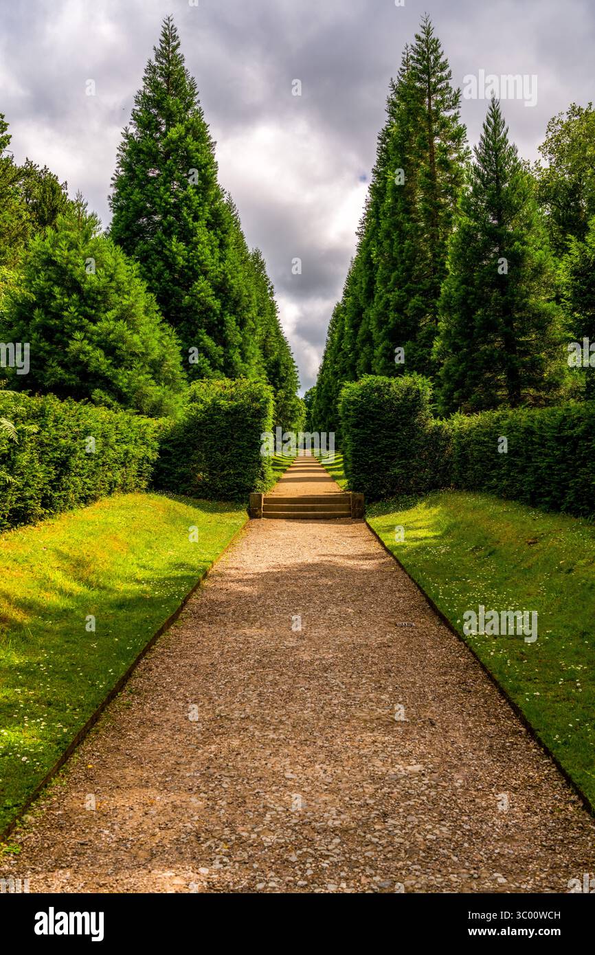 British Formal Garden Pathway with Symmetrical Evergreens and Dramatic ...