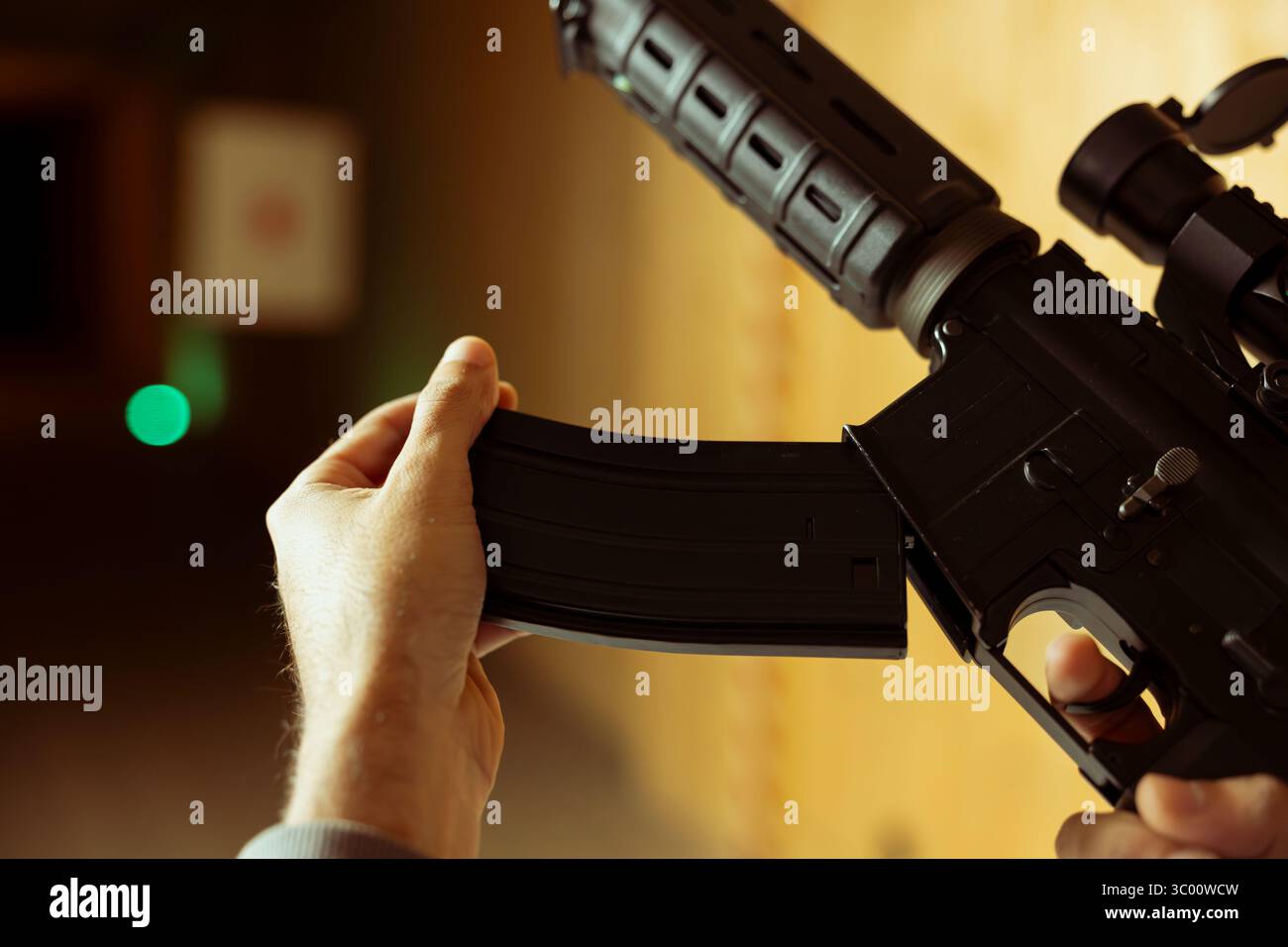 Shooting range client trying rental semiautomatic weapons, loading ...