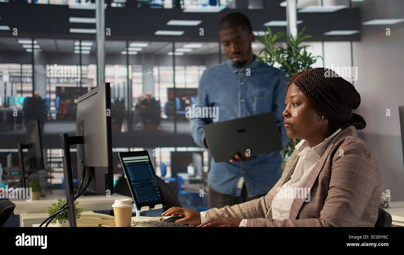 African american team members engaged in administrative tasks with ...
