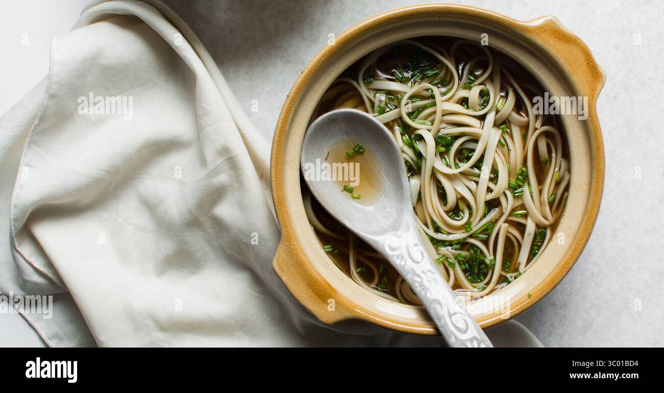 overhead view of soy sauce noodles with sliced green onions, top view ...