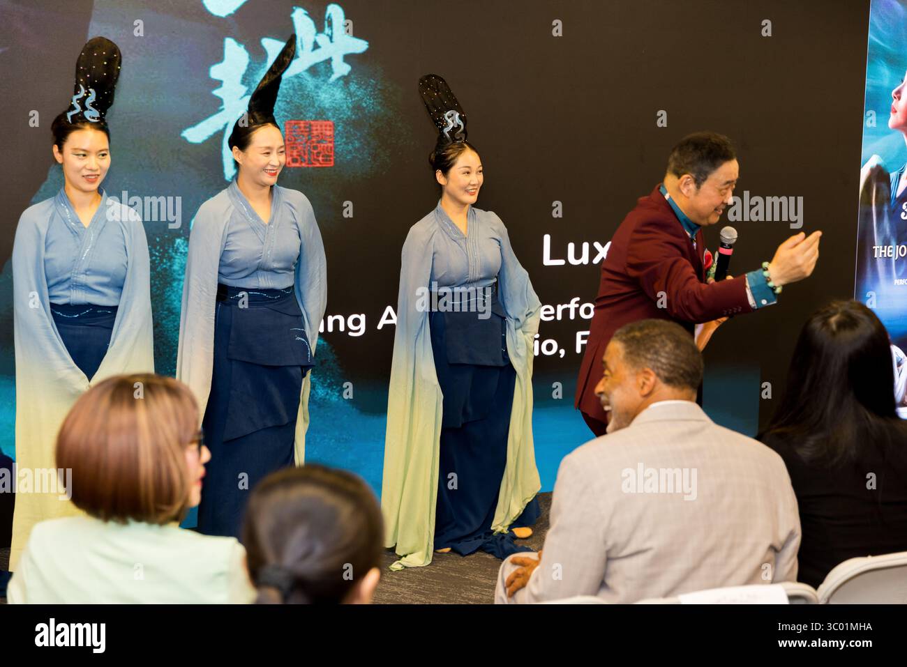 Joey Zhou TV Host/ LABA founder onstage with performers at Conference ...