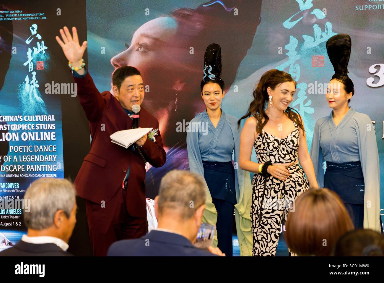 Joey Zhou TV Host/ LABA founder onstage with performers at Conference ...