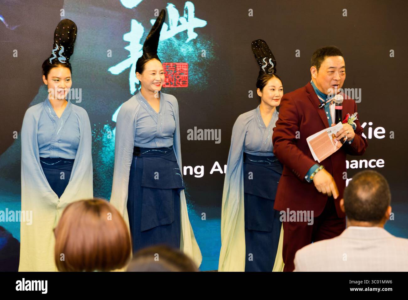 Joey Zhou TV Host/ LABA founder onstage with performers at Conference ...