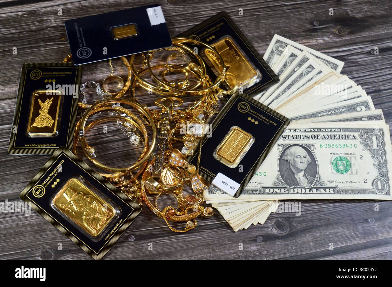 Cairo, Egypt, July 17 2025: USD American dollars currency, 24K karat BTC Bullion Trading Center ...