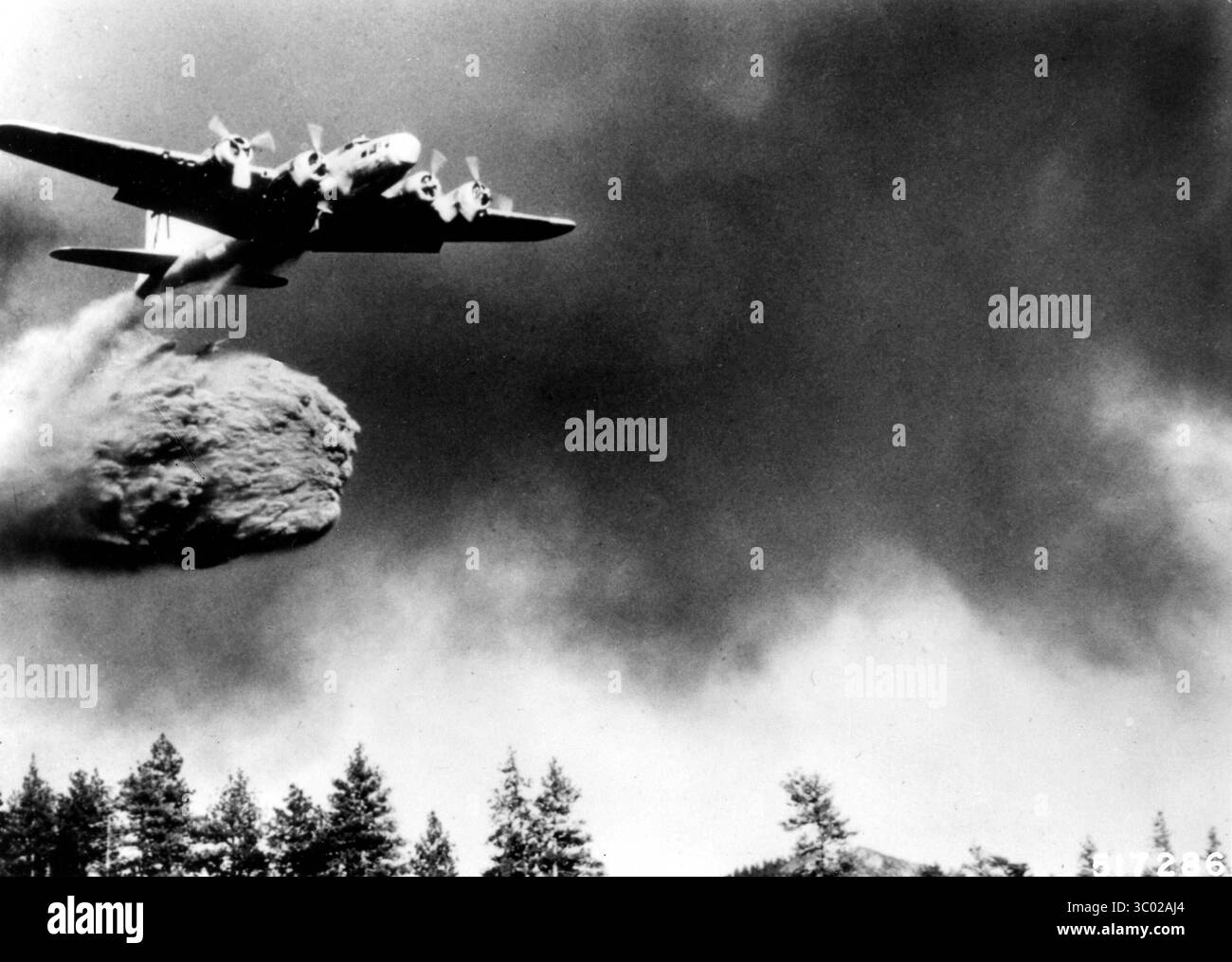 Black and white photo of Boeing B-17 Flying Fortress dropping fire ...