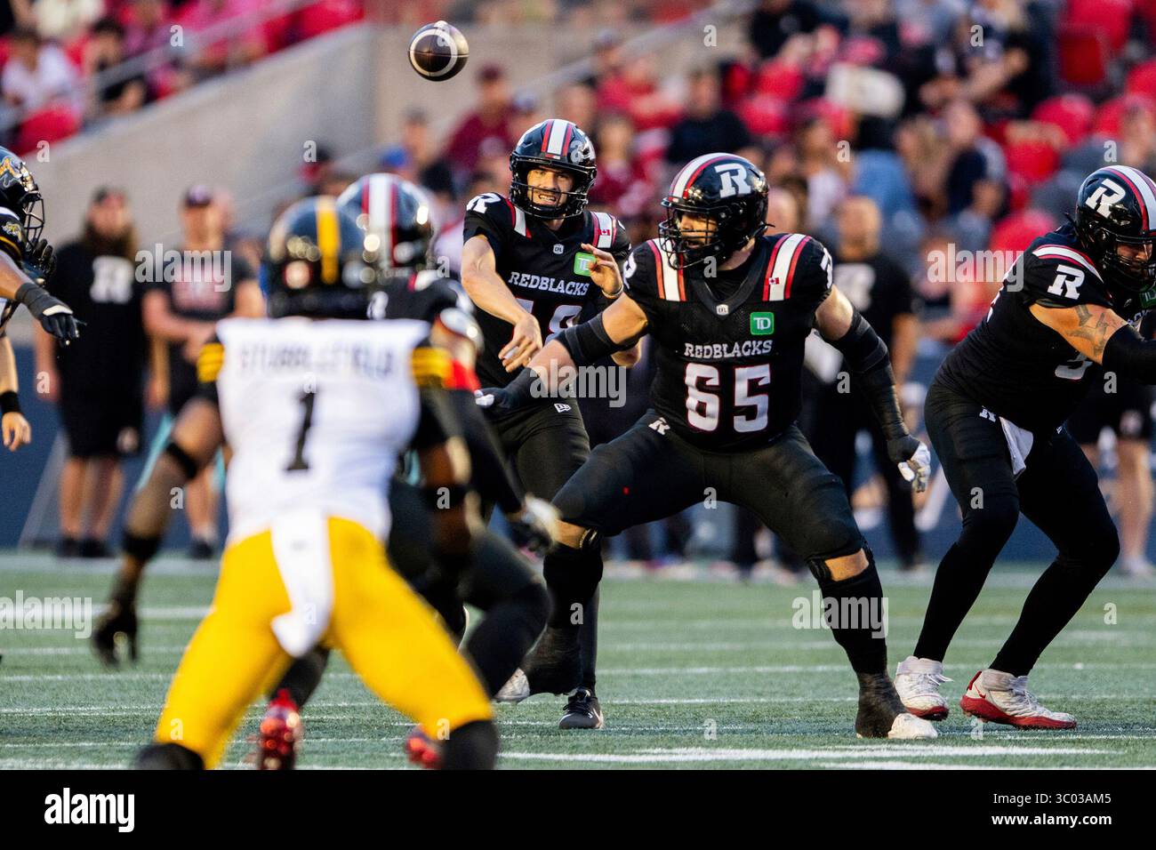 Ottawa Redblacks quarterback Dustin Crum, third from right, throws a ...