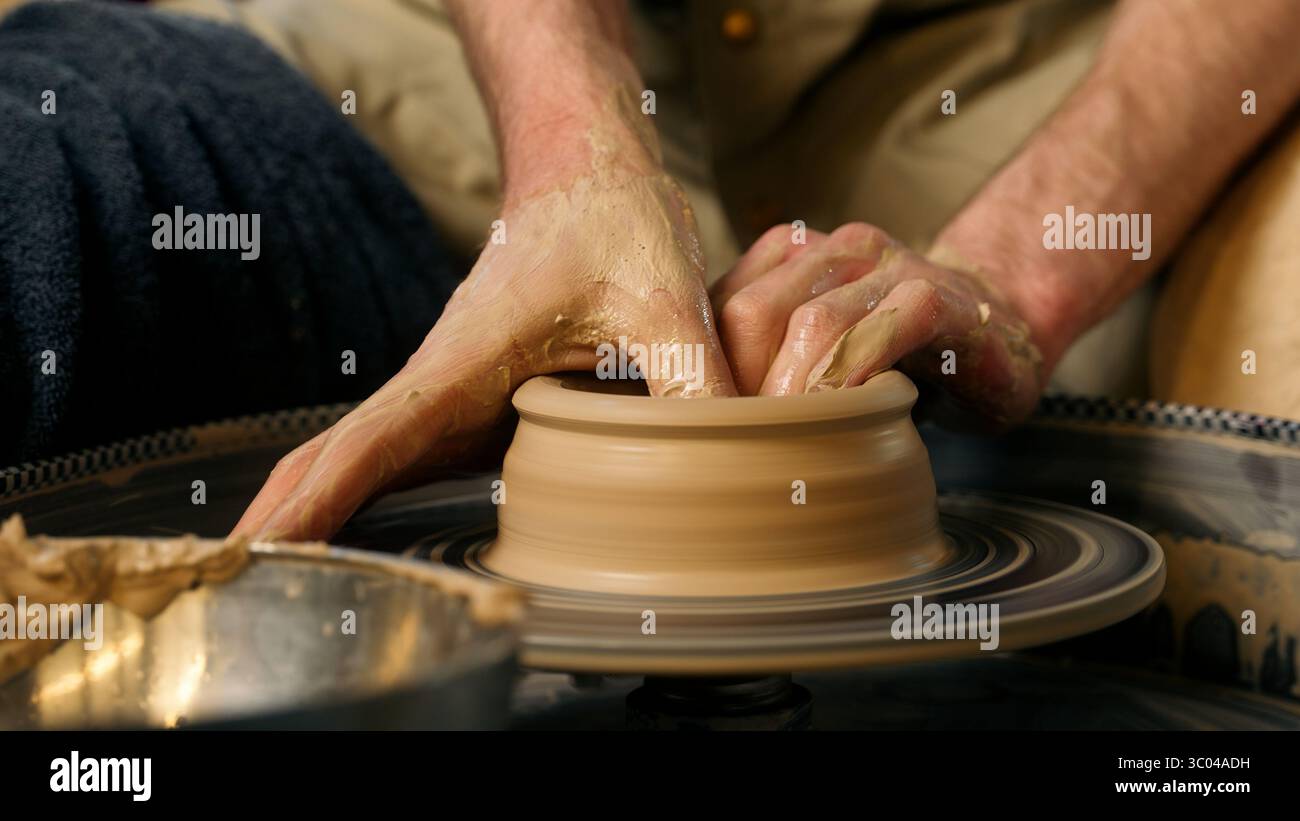 Hands unrecognizable artisan man master craftsman creating form shaping ...