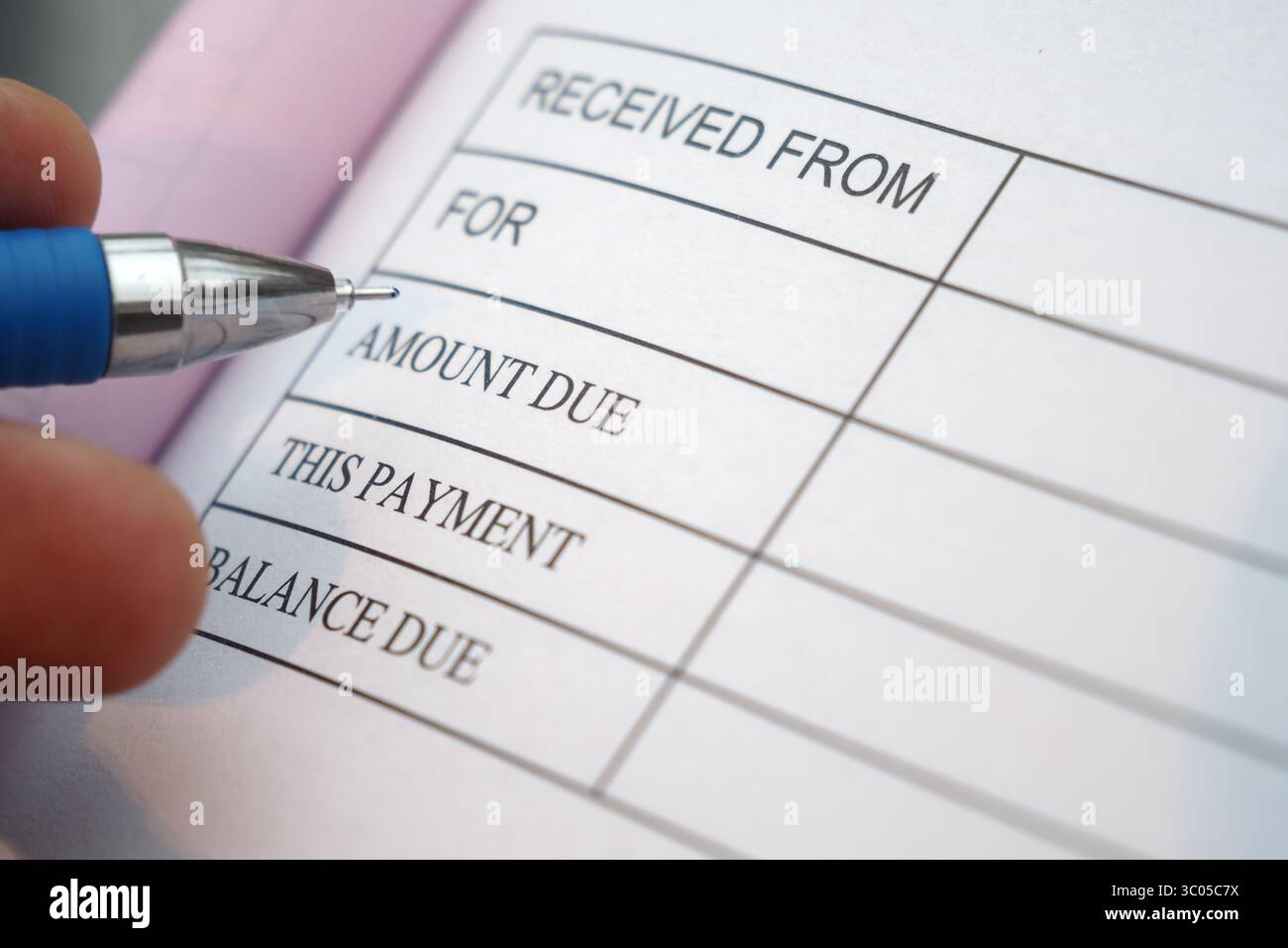 Hand writing in a receipt document with a blue pen Stock Photo - Alamy