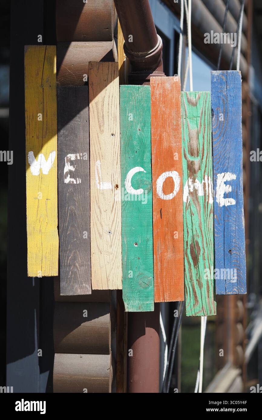 Colorful wooden welcome sign at a rustic location Stock Photo - Alamy