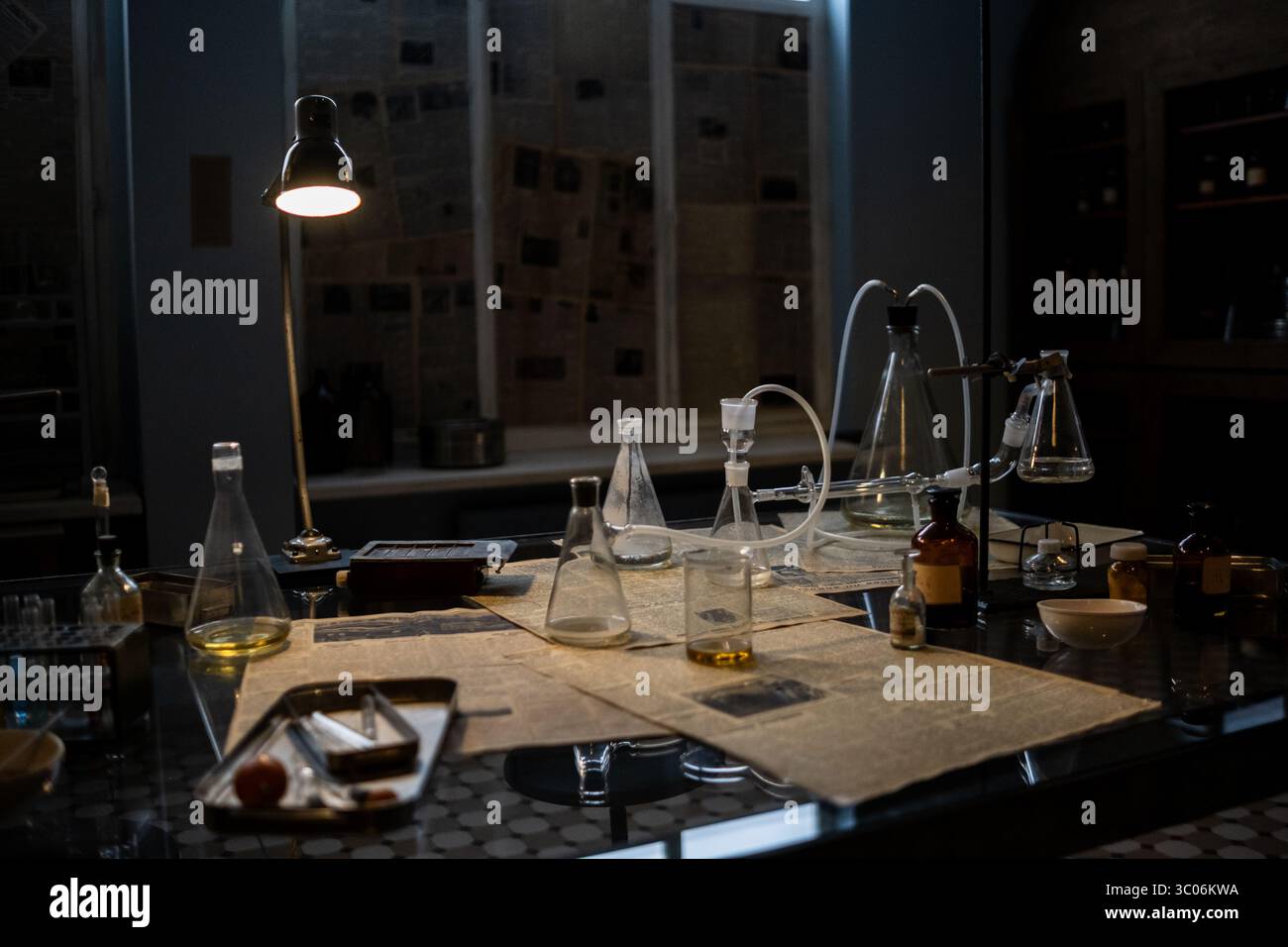 A laboratory features various glass flasks and equipment arranged on a ...