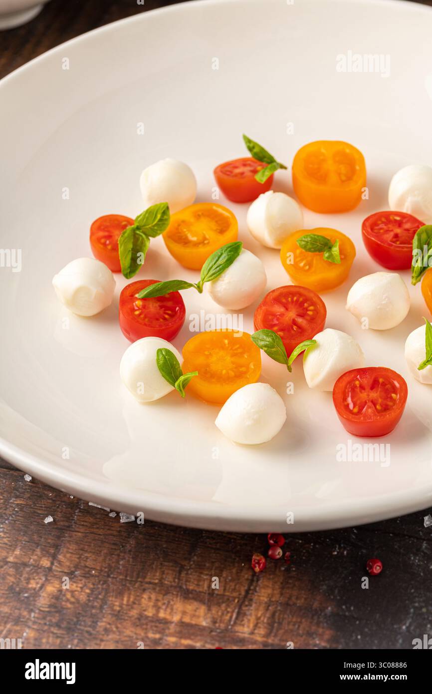 Colorful Caprese salad with cherry tomatoes, mozzarella and fresh basil ...