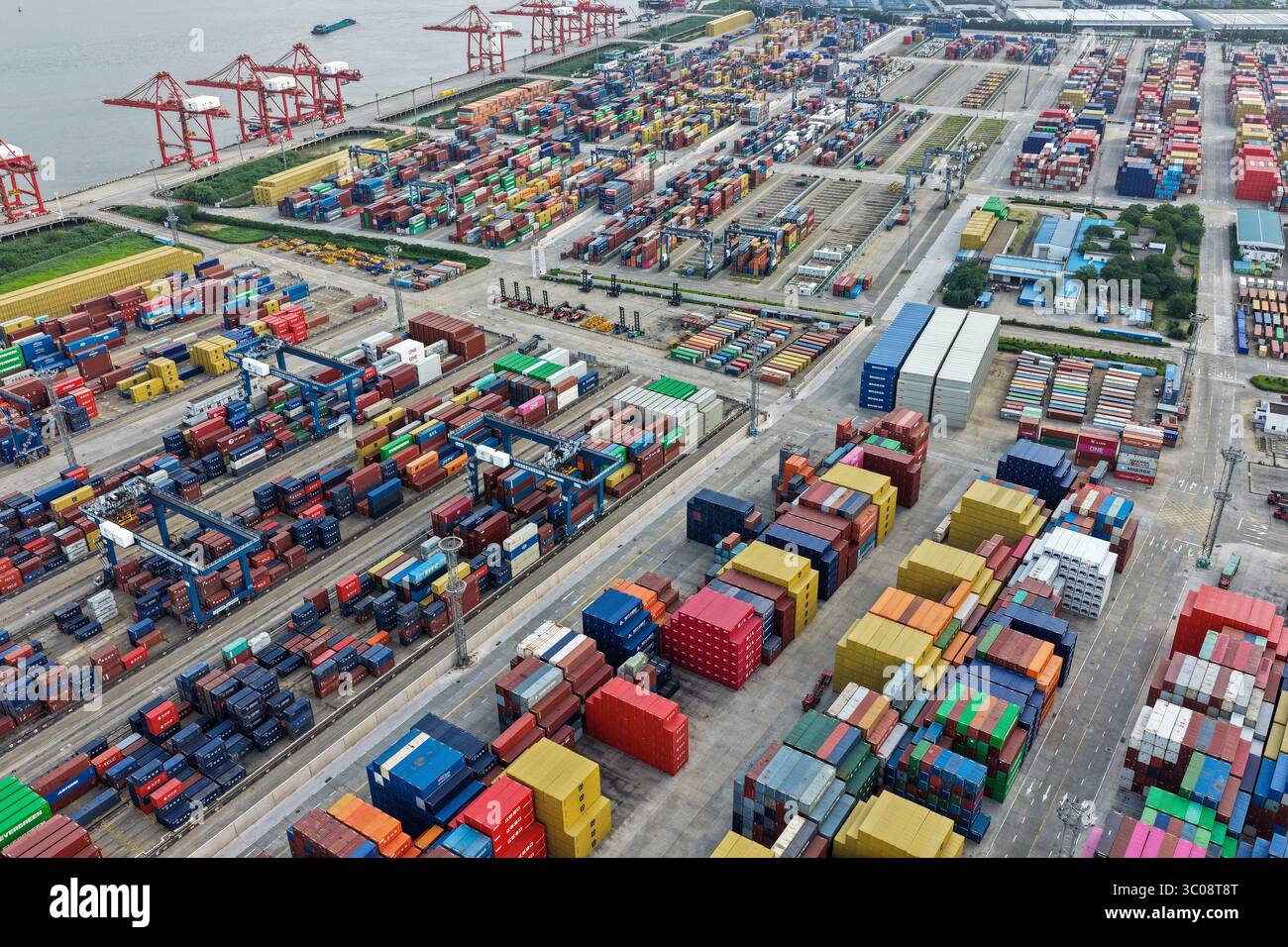 Containers piled up at the berths of the container terminal in Longtan ...