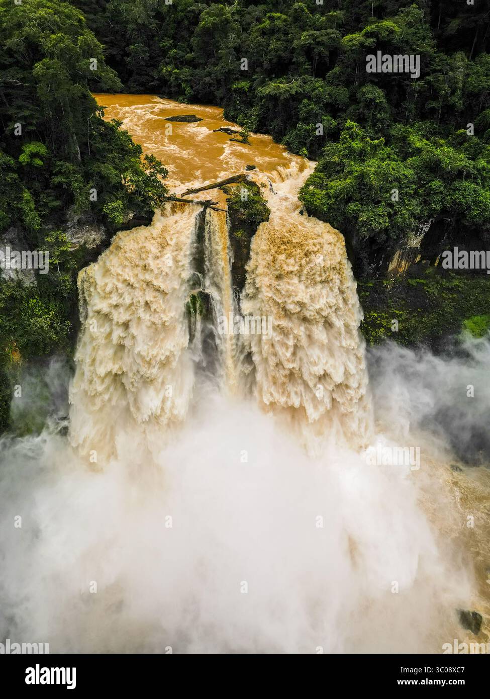 Aerial view of the powerful Ekom Nkam Falls plunge with muddy waters ...