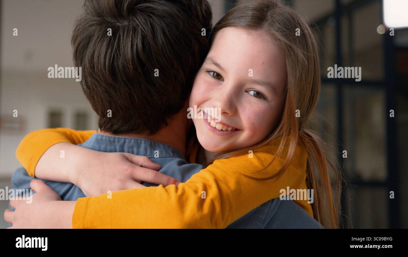 Smiling Caucasian daughter kid hugging embracing dad man parent guy at ...