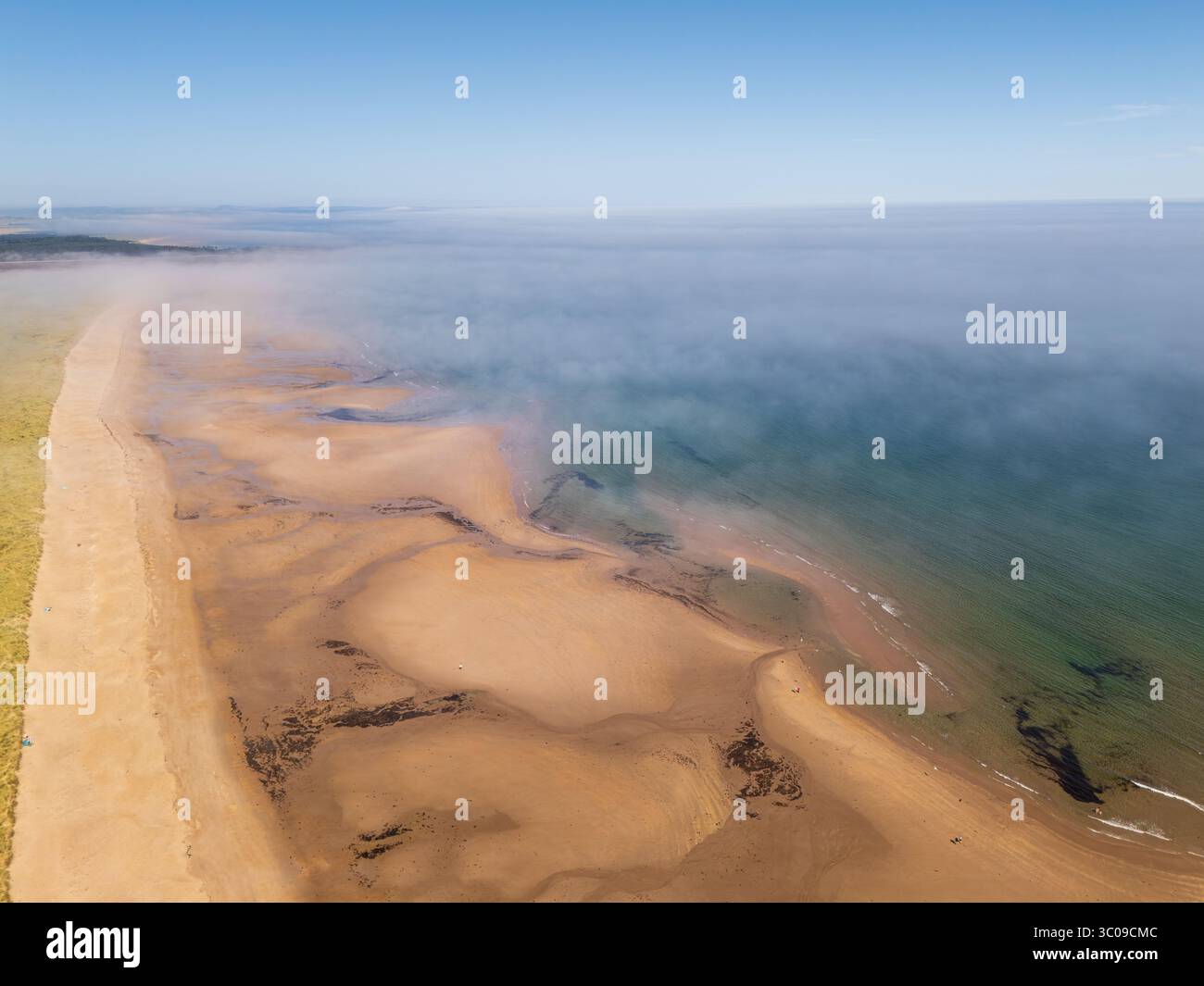 Aerial view of golden sands meeting the misty horizon, where the North ...