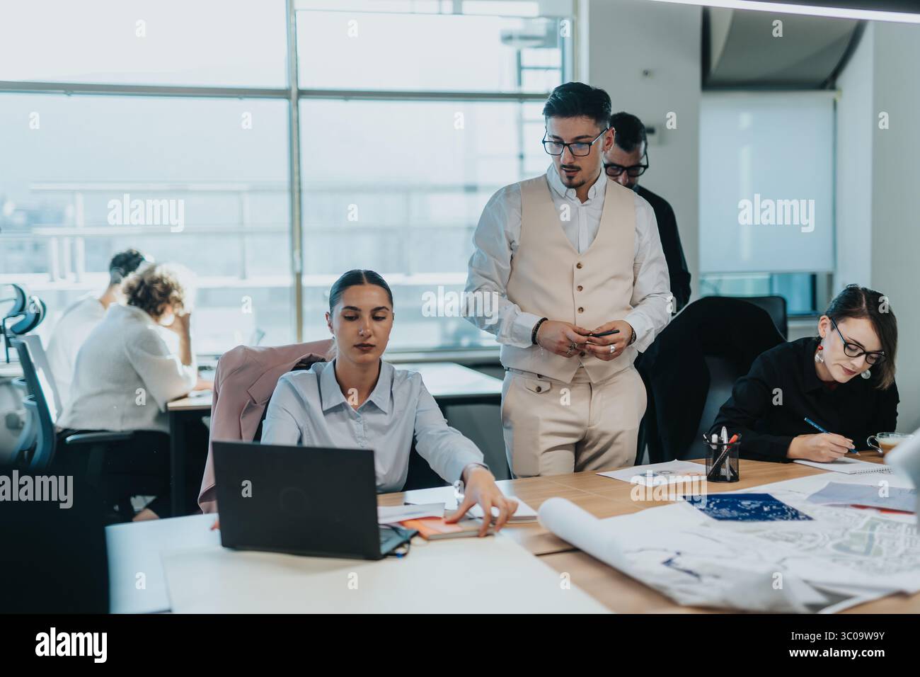 A diverse group of business employees engaging in a collaborative work ...