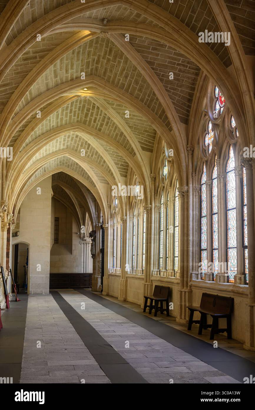Gothic vaulted cloister gallery with stained glass and medieval ...
