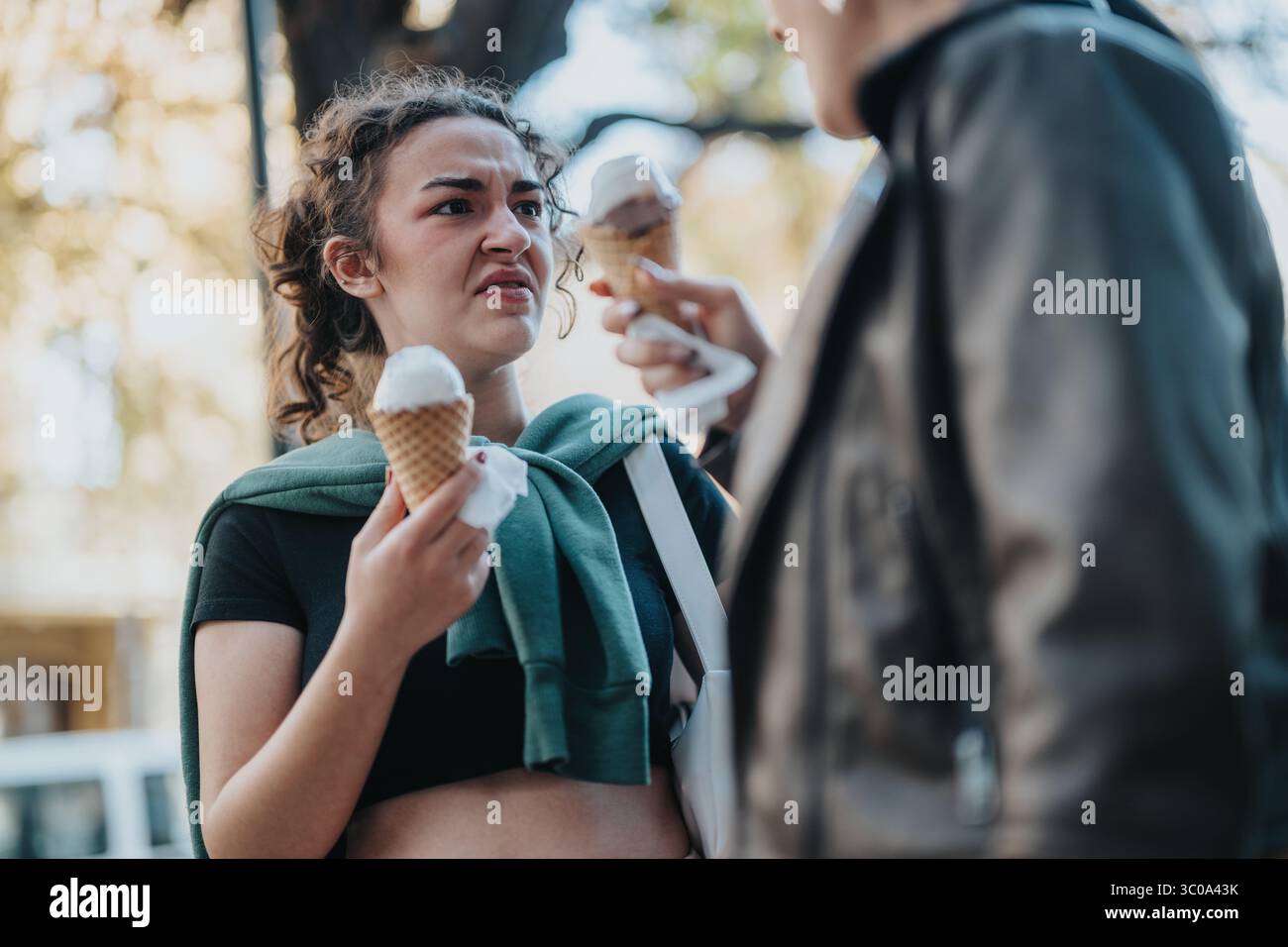 Friends enjoy ice cream outdoors with unique and expressive facial ...