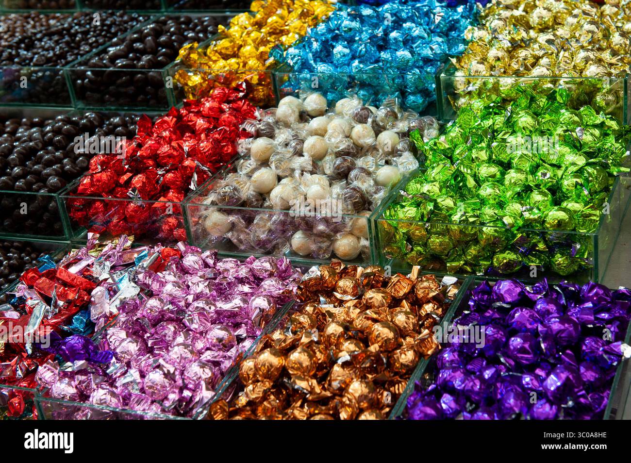 Bulk bins filled with an assortment of individual, colorful, foil ...