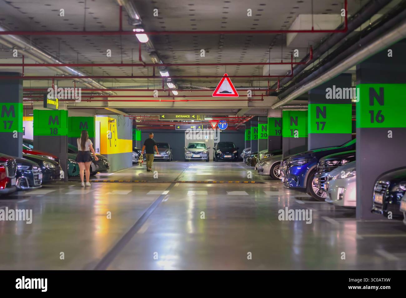 Rows of cars, Parking Garage. Modern underground parking with green ...