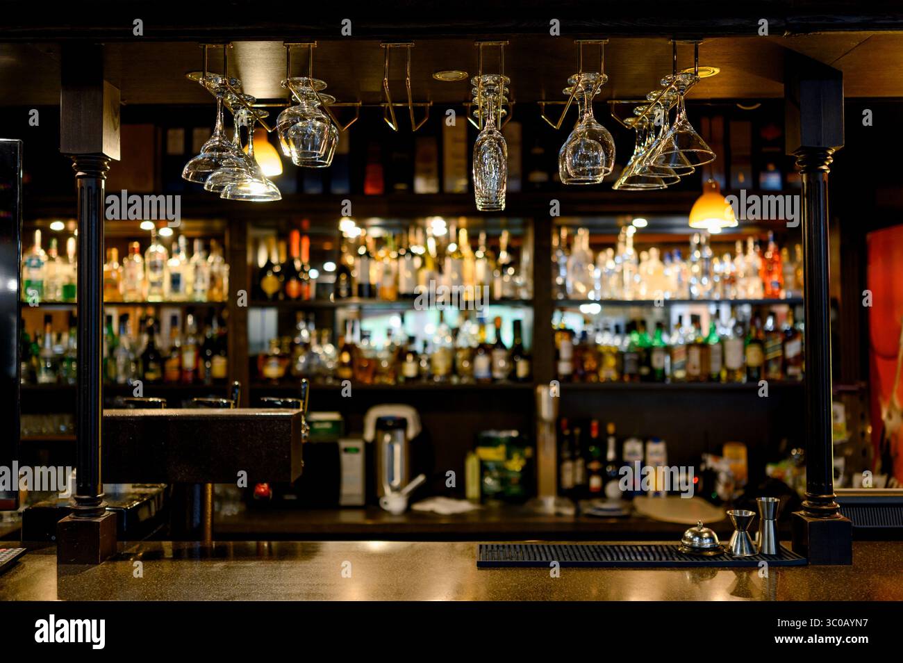 a bar counter with shelves filled with various bottles of alcohol and ...