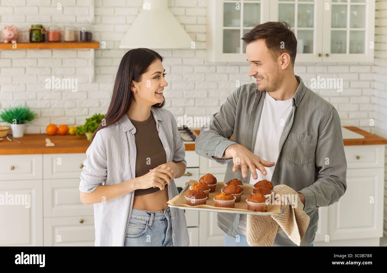 Happy loving young couple holding tray with yummy self baked tasty ...
