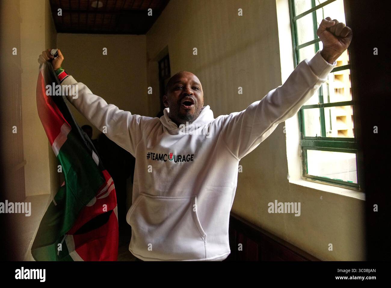 Prominent Kenyan activist Boniface Mwangi sings while holding a Kenyan ...