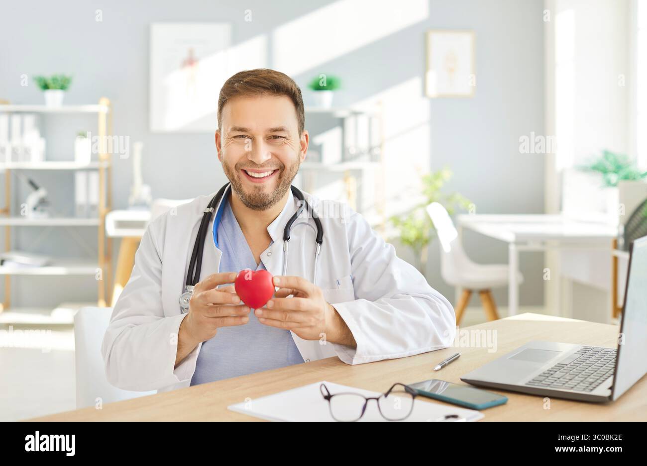 Cardiologist with smile is seated in medical office, showcasing vibrant ...