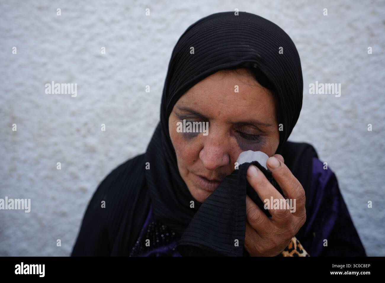 21 July 2025, Syria, Daraa: A displaced Bedouin Syrian woman ices her ...