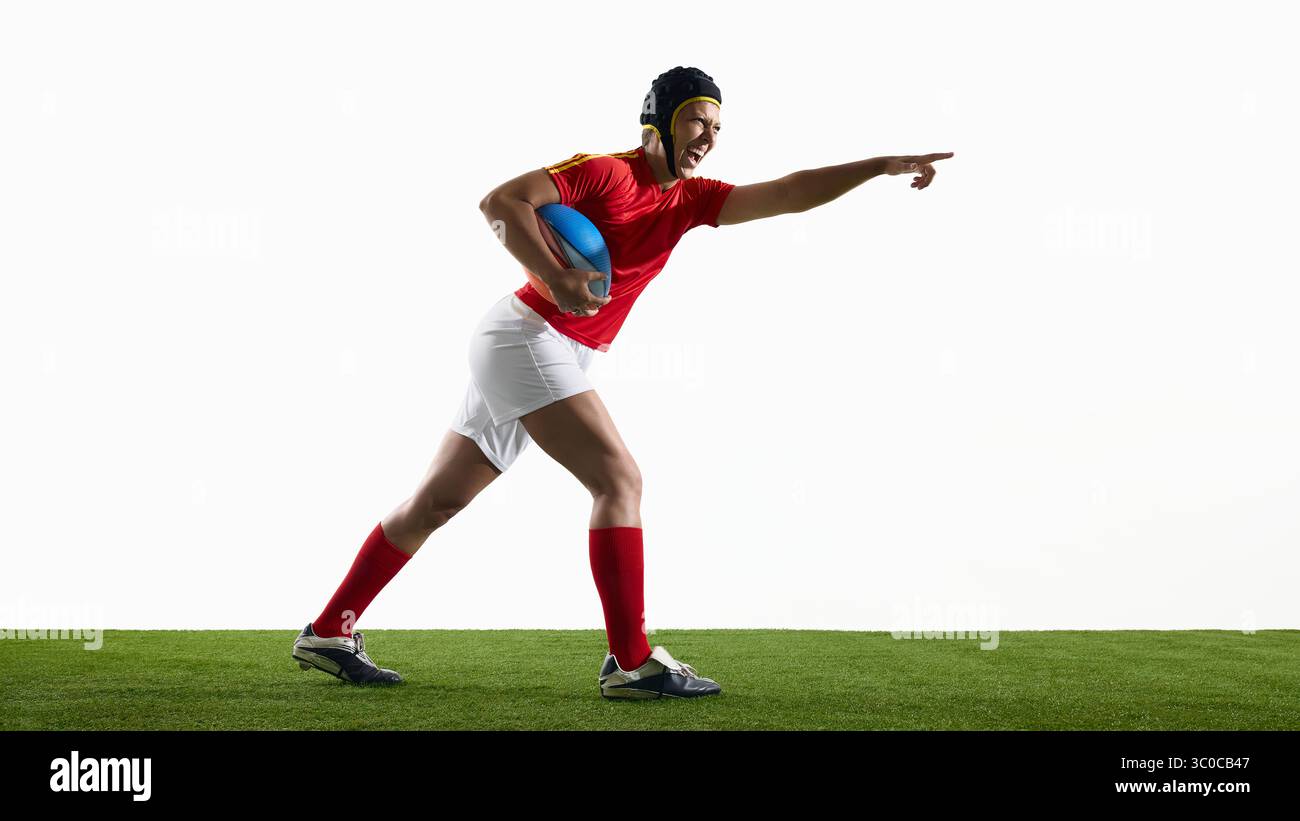 Rugby athlete advancing on grass pitch with outstretched arm Stock ...