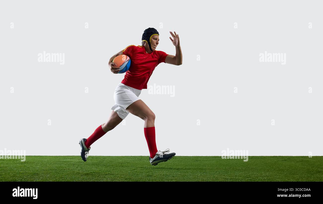 Woman rugby player running on grassy field in attire Stock Photo - Alamy