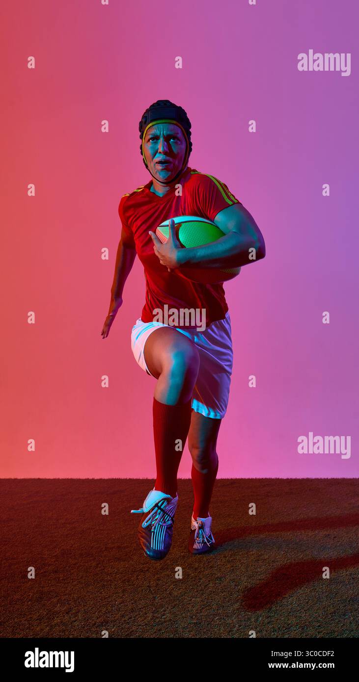 Female rugby player running with ball under vibrant pink and purple ...