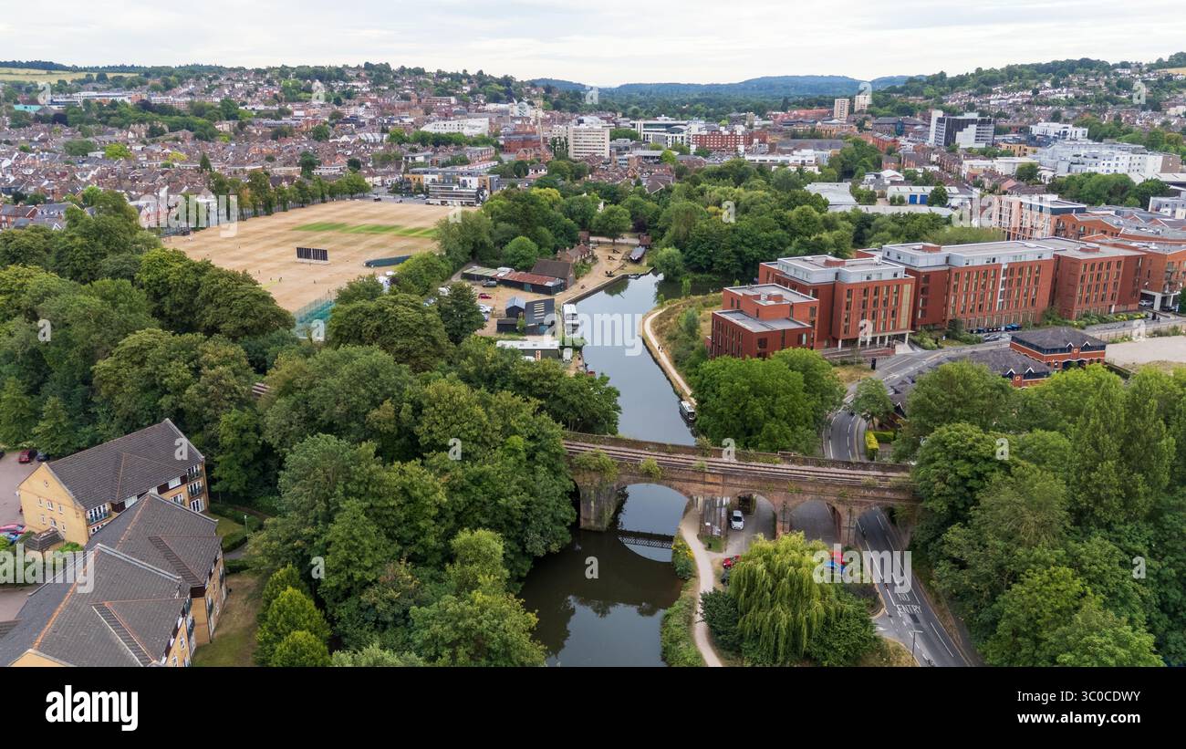 Aerial view of the River Wey flowing under a stone bridge, surrounded ...