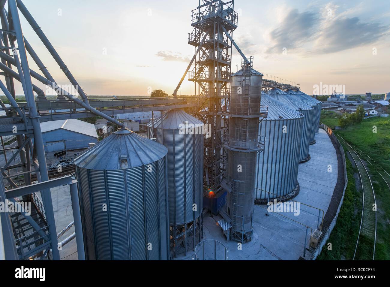 Aerial view of a modern grain elevator and metal silos on a farm ...