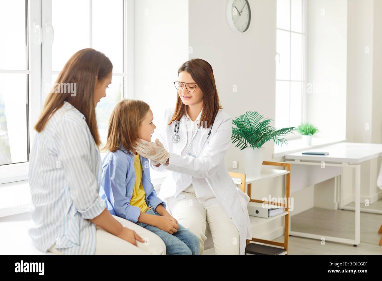 Pediatrician Attending Boy Patient With His Mother At The Hospital ...