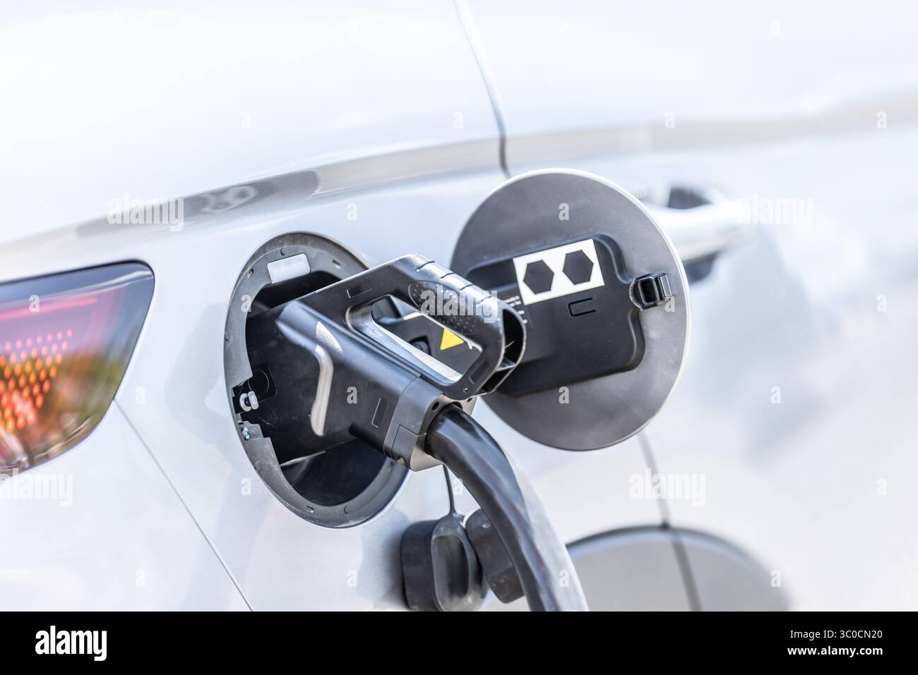 Focus closeup electric vehicle plugged in with EV charger device from ...