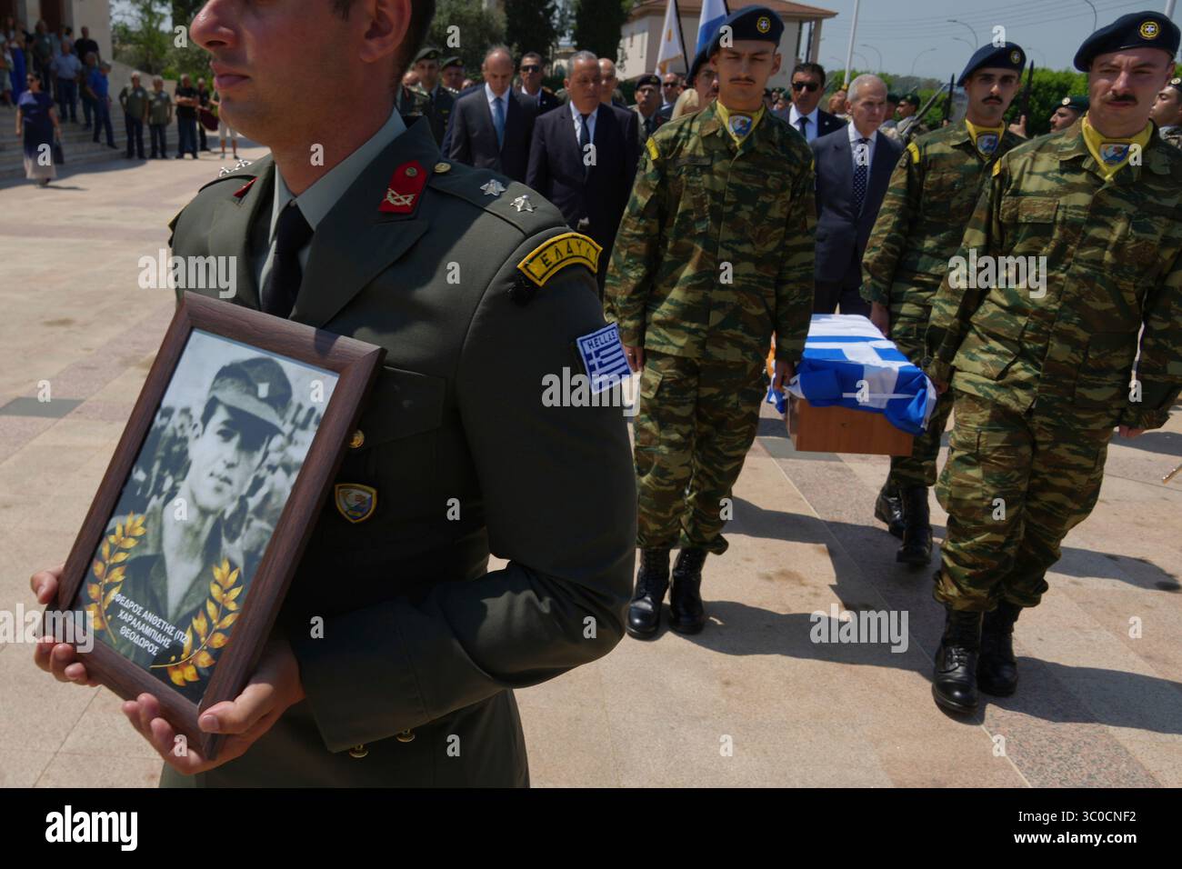 Soldiers carry the coffin of a Greek soldier who was listed as missing ...