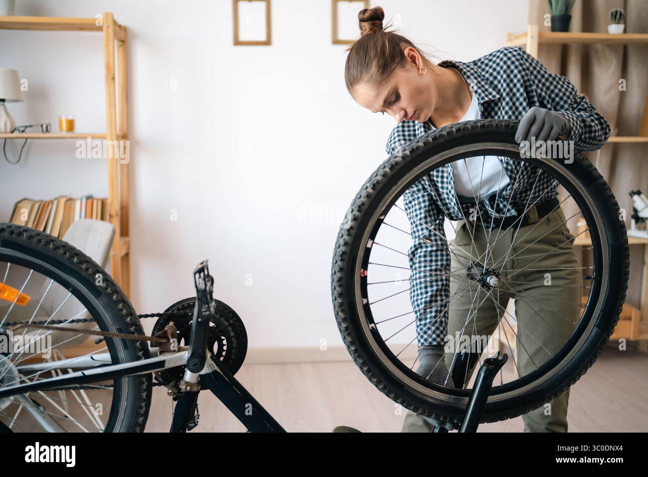Young woman repairing bicycle new hi-res stock photography and images ...