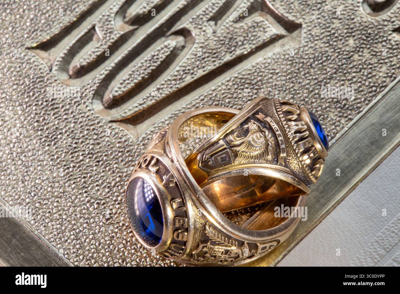 Still life of a girls and boys high school rings on top of the 1967 ...