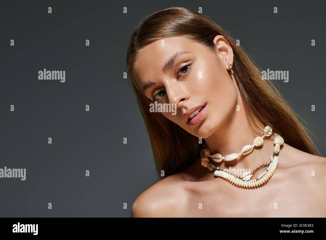 Young woman poses elegantly in a summer outfit, accentuated by a ...