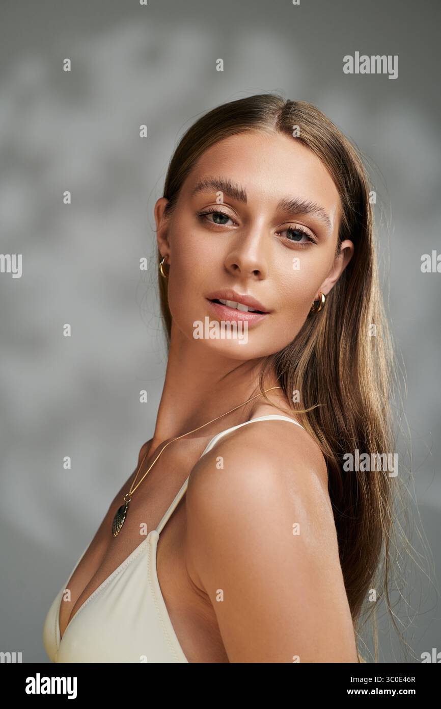 A stunning young woman showcases her natural beauty with tan skin in ...