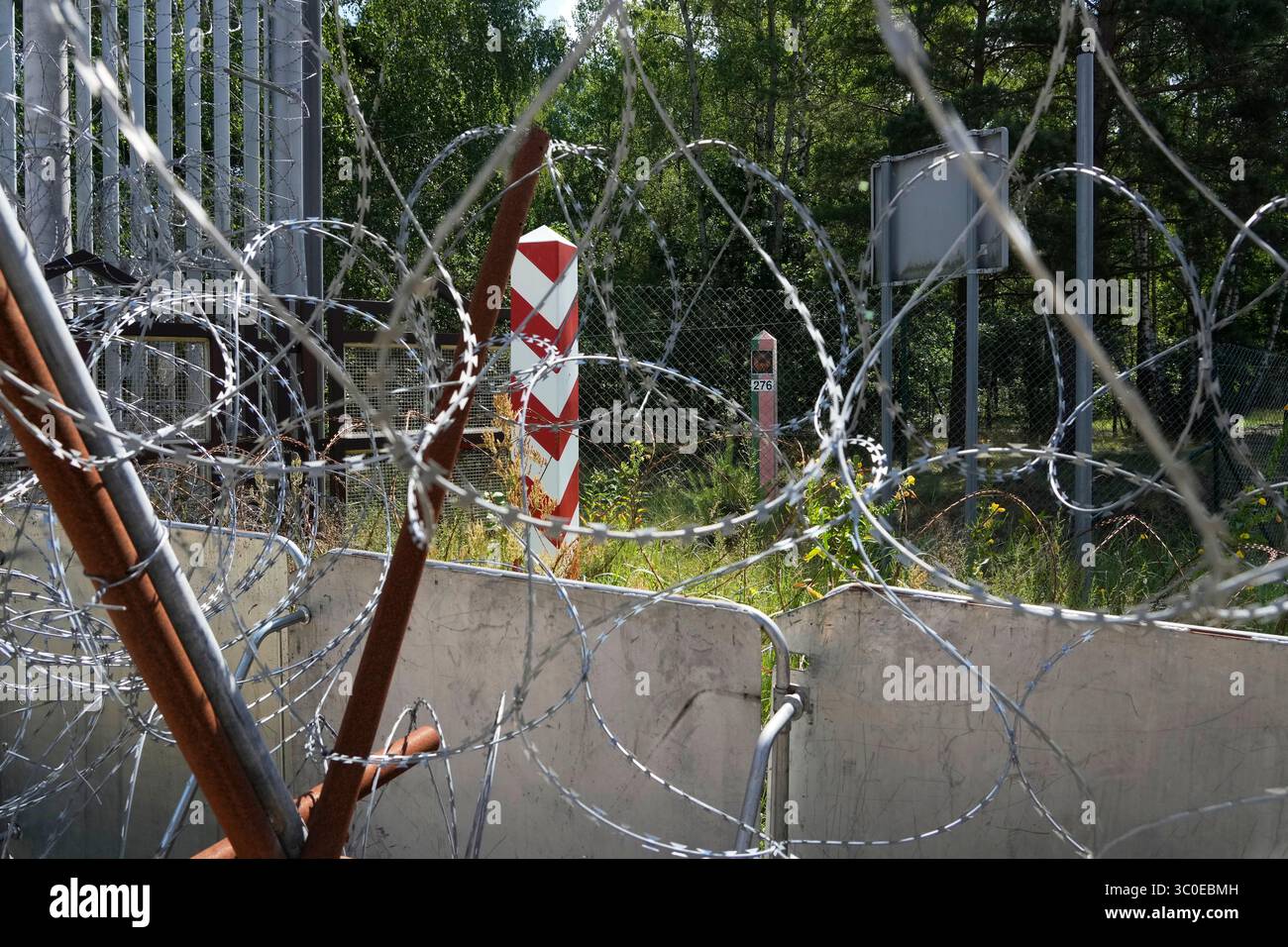Barbed wire and border posts are seen at the Polish-Belarusian border ...