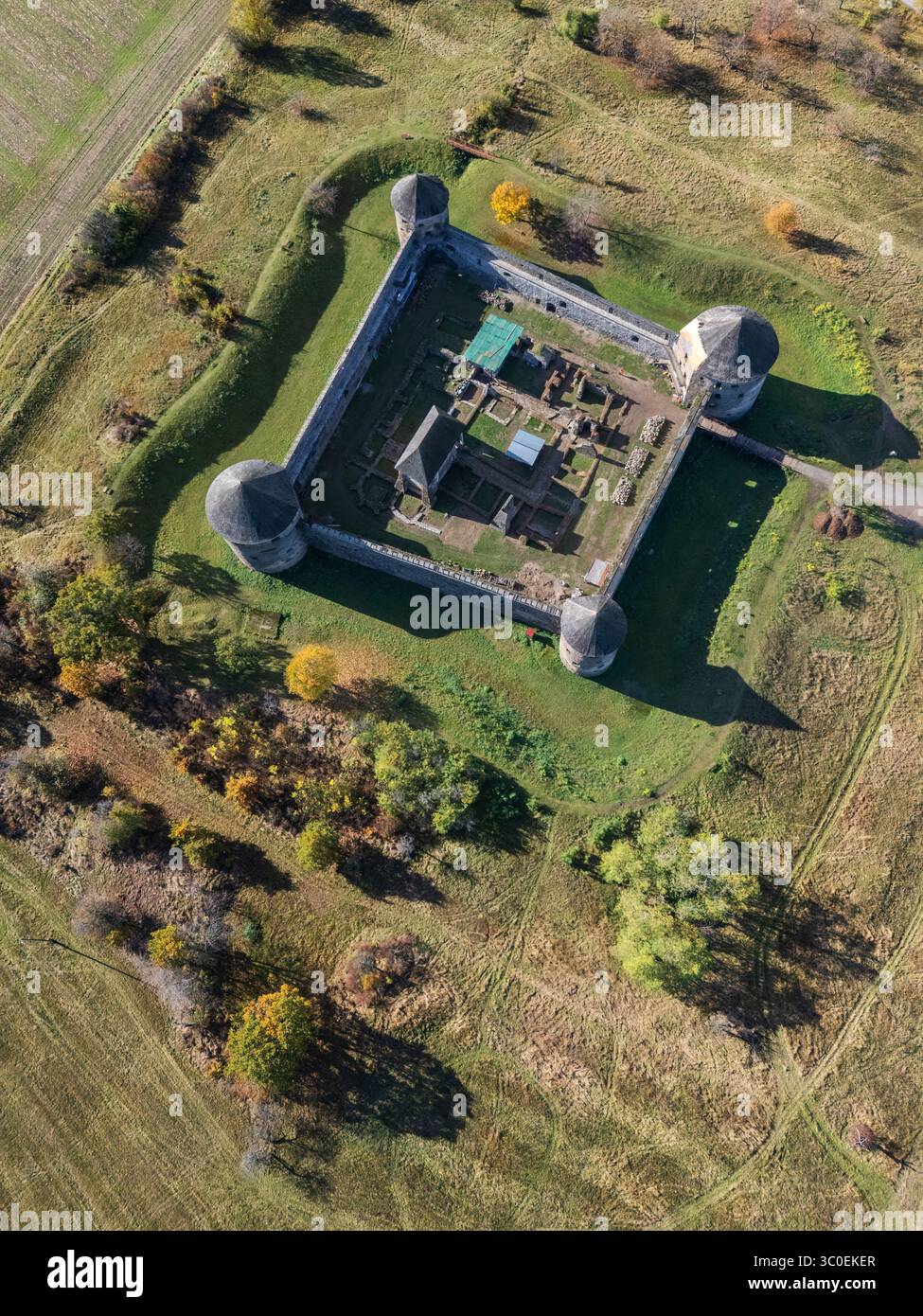 Aerial view of stone fortress with rounded towers, surrounded by a moat ...