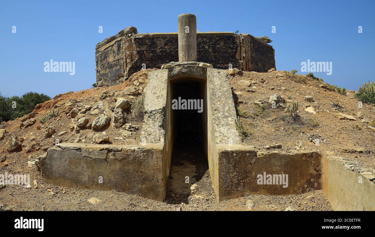 Entrance to a concrete structure on a rocky, dry hill, Lost Place, Air ...