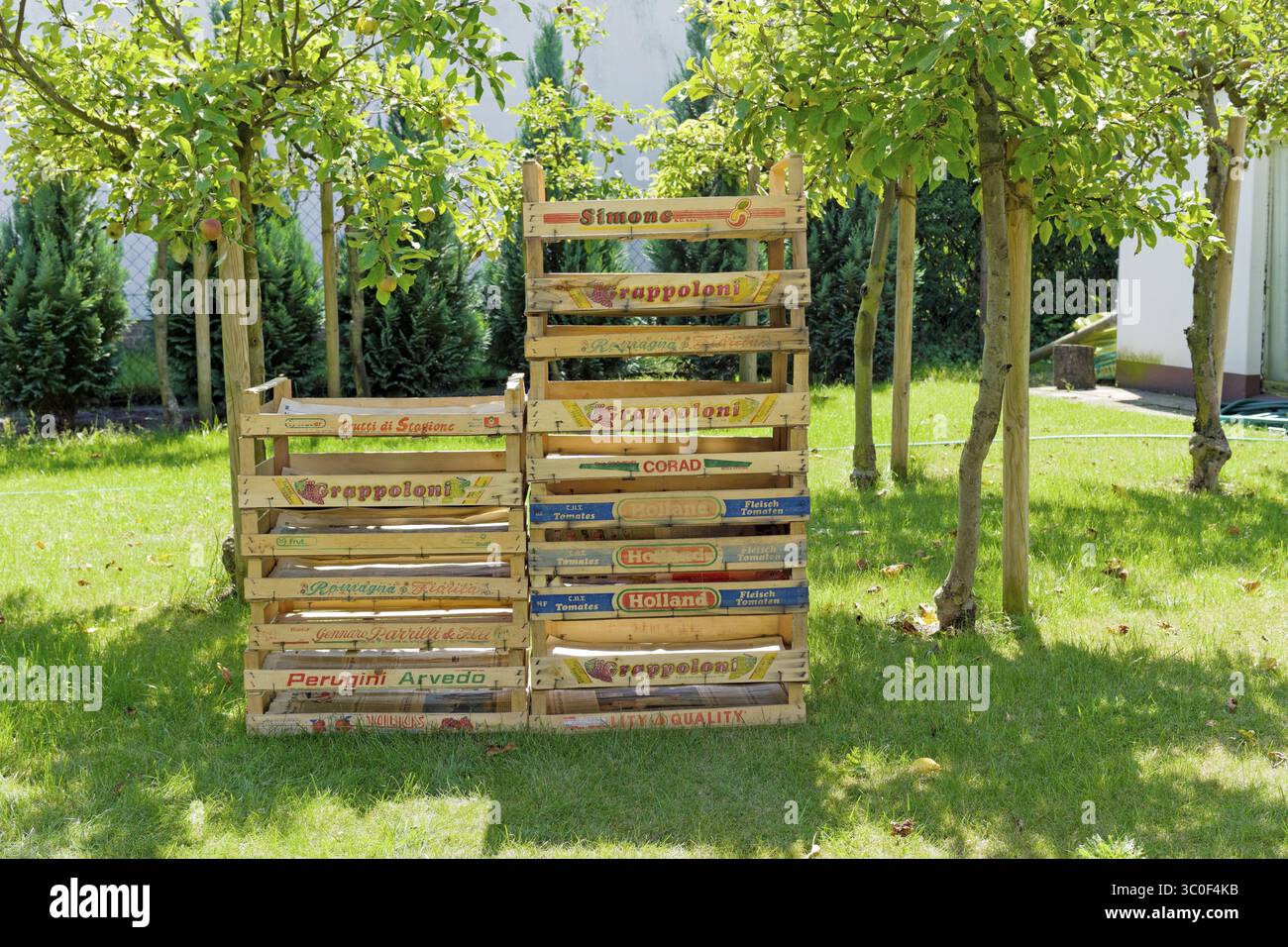 Stacked fruit crates for the apple harvest Stock Photo - Alamy