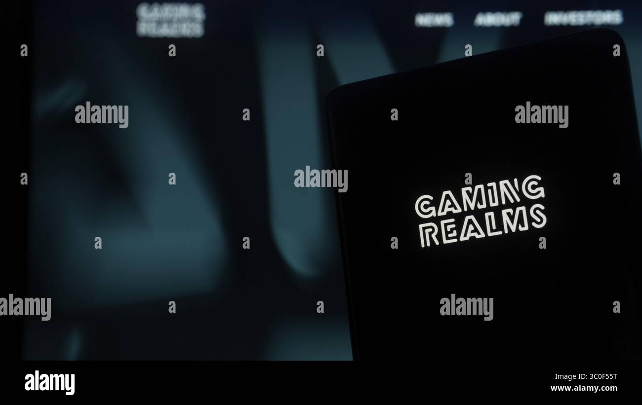 Gaming Realms logo in white on a black screen with a website backdrop ...